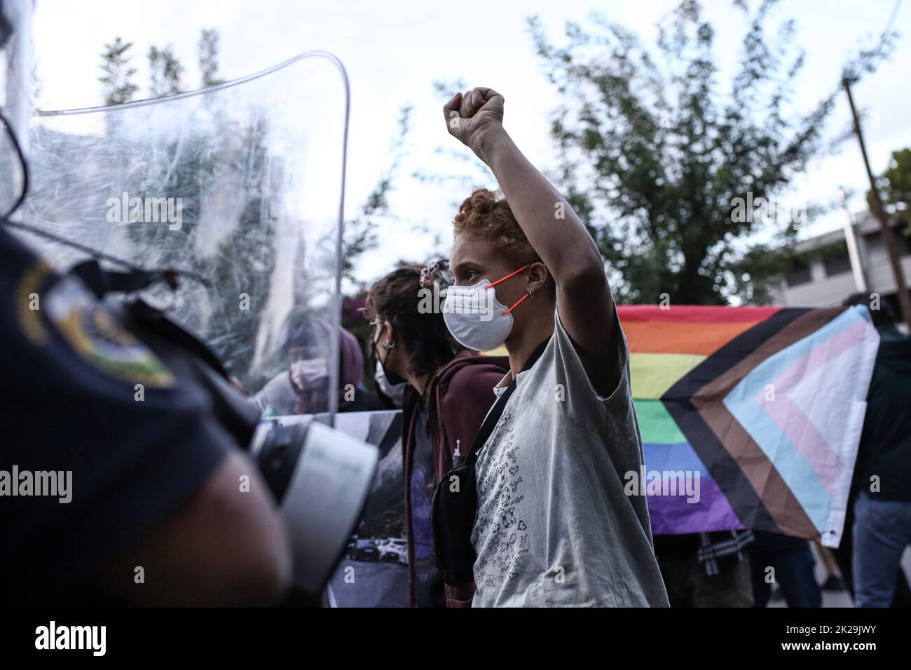 Women shout slogans at the riot police in front of the Iranian Embassy ...