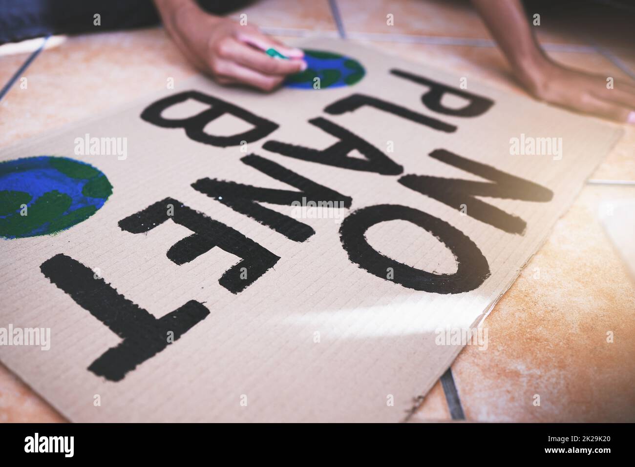 Hands, global warming and protest writing on cardboard woman support ...