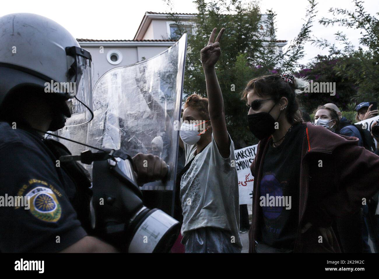 Women shout slogans at the riot police in front of the Iranian Embassy ...