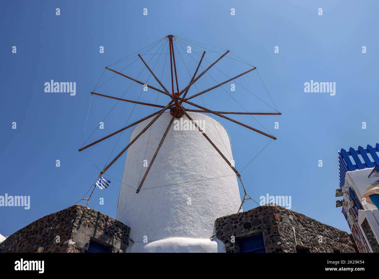 Traditional white windmill in Oia on Santorini. Cyclades, Greece Stock ...