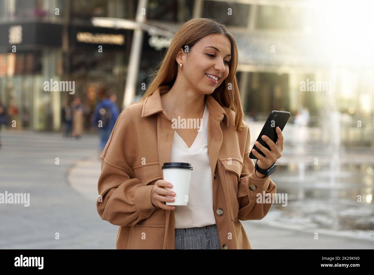 Entrepreneur young. Busy woman. Smartphone app. Office worker outdoors ...