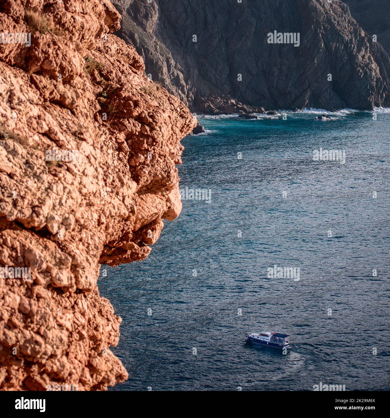 Landscape, sea, rocks, mountains, and a small boat on the waves Stock ...