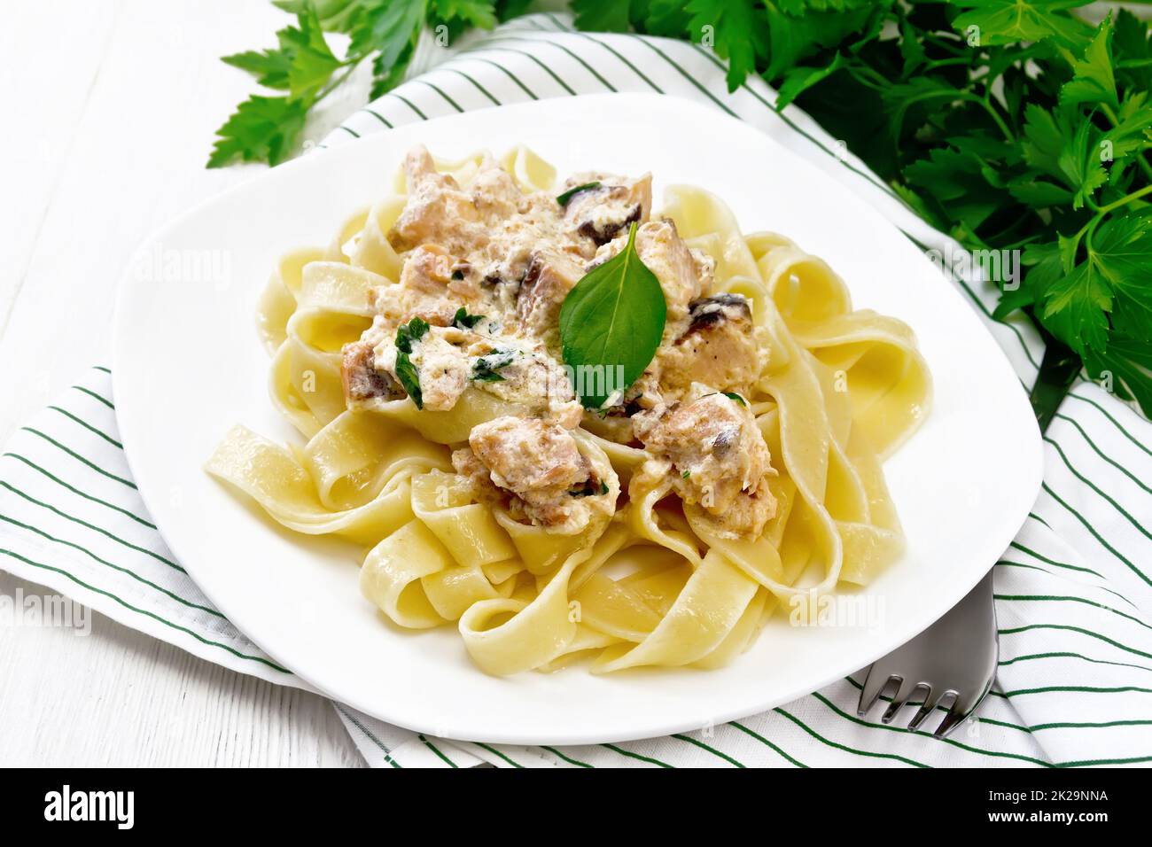 Pasta with salmon in cream on light board Stock Photo - Alamy