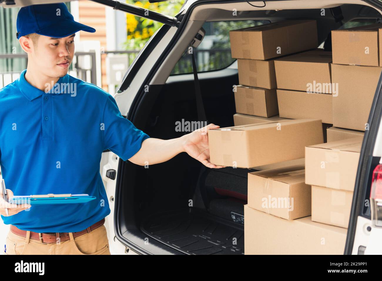 man courier in uniform hold documents clipboard checking list parcel ...