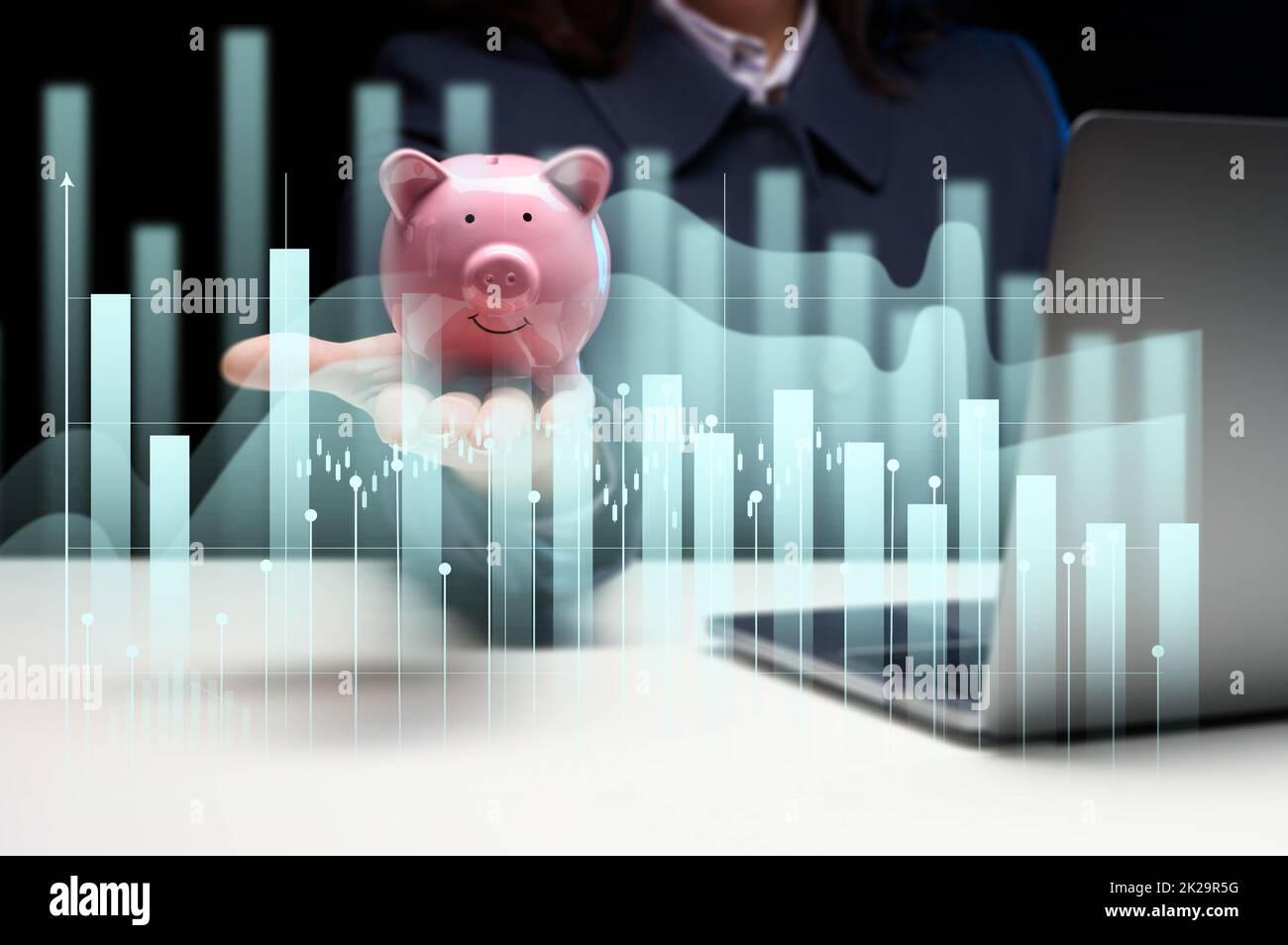 female hand holds a pink ceramic piggy bank against the background of a ...