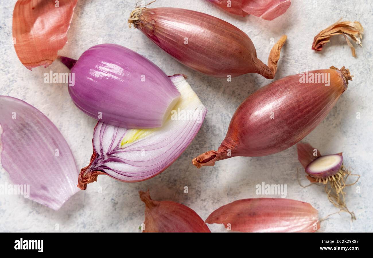 Peeled Red tropea onions on a white table top view Stock Photo - Alamy