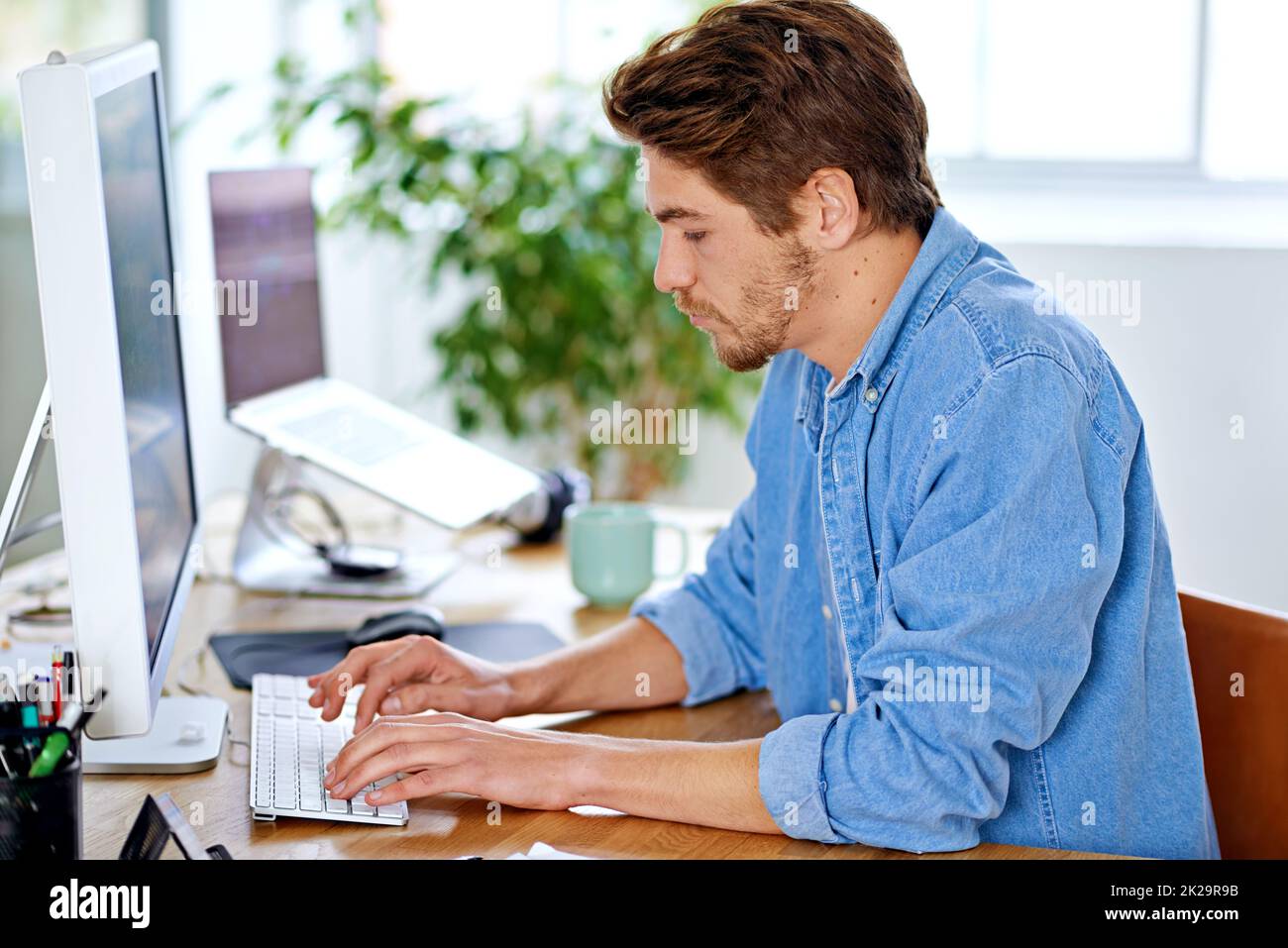 Modern technology is the creator of new jobs. a handsome young designer ...