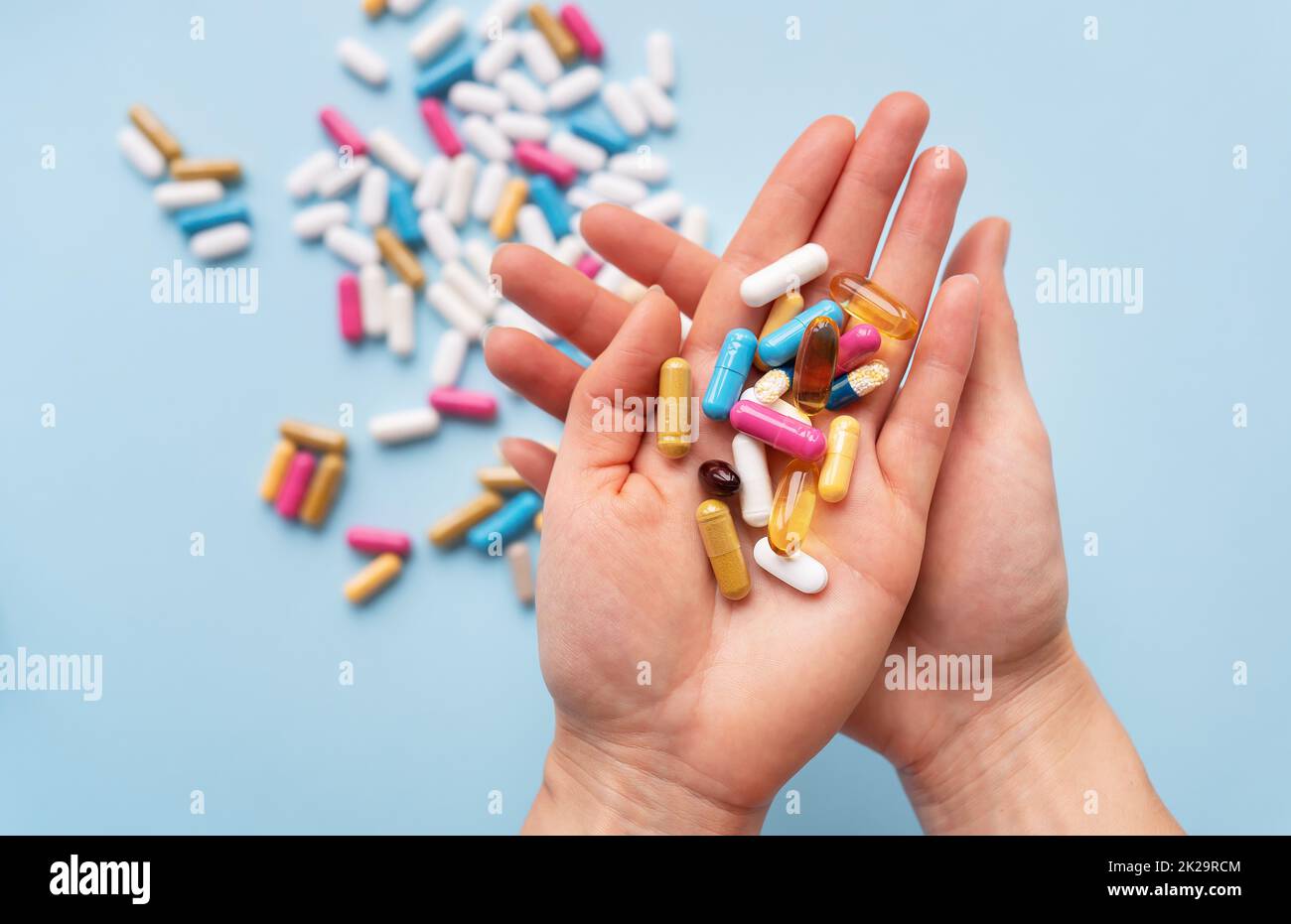 Hand holds colored pills hi-res stock photography and images - Alamy