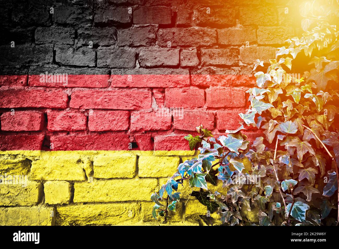 Germany grunge flag on brick wall with ivy plant sun haze view Stock ...