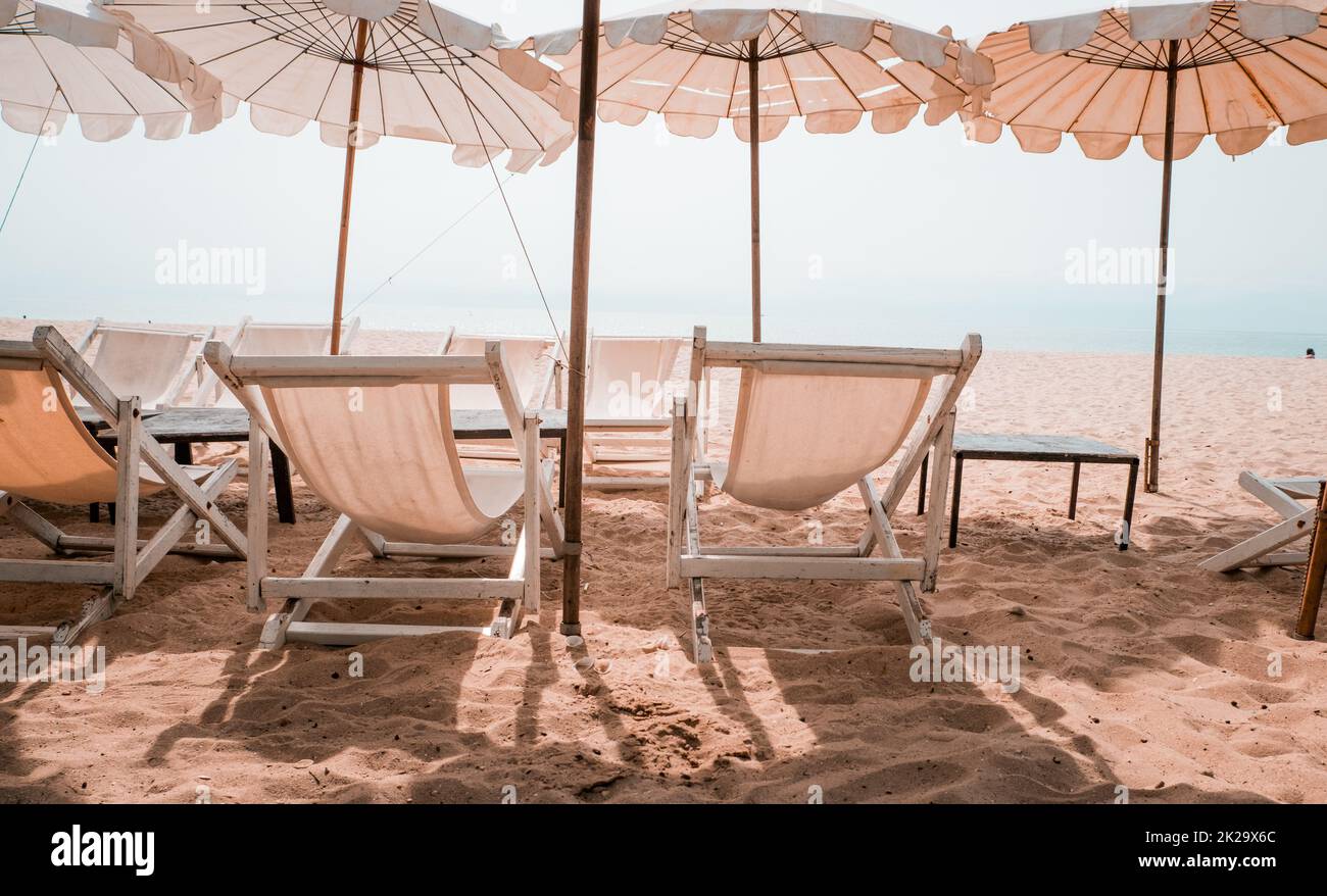 Deckchairs And white Parasol In The Tropical Beach. white umbrella on ...