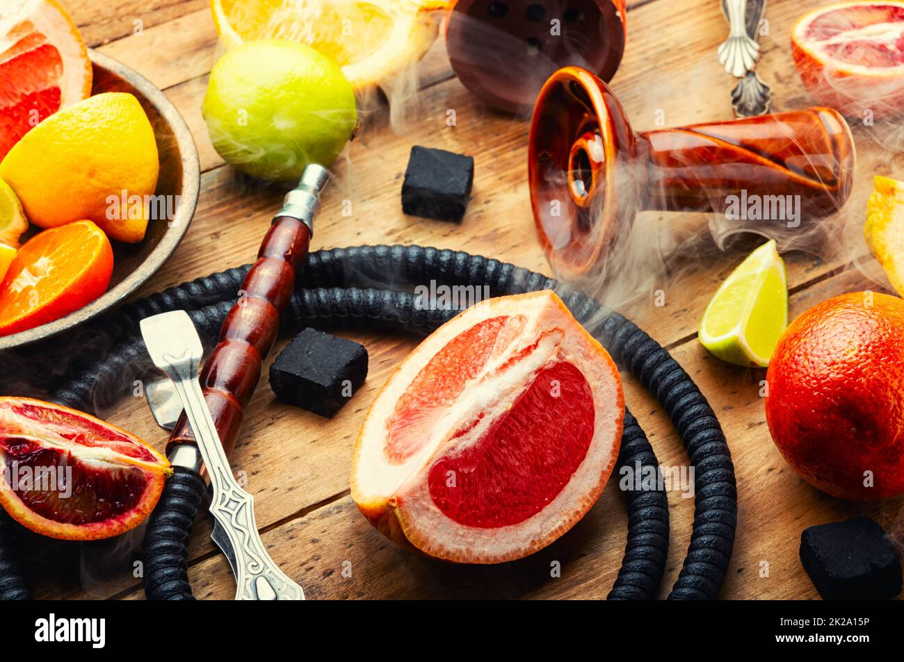Smoking hookah with citrus fruits Stock Photo - Alamy