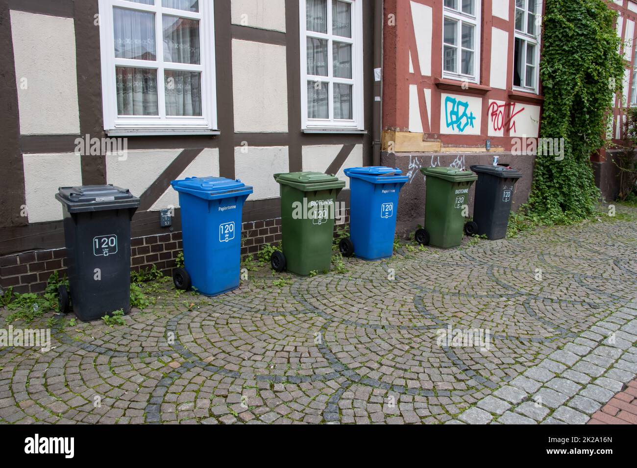Garbage cans in front of residential buildings for waste separation ...