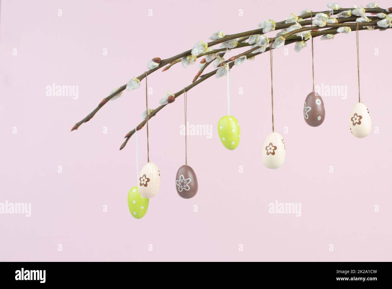 Easter holiday background, small eggs hanging on pussy willow branches ...
