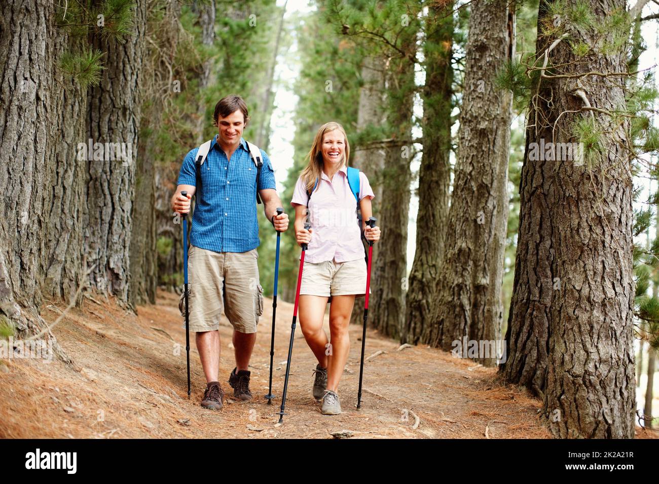 Couple on a hike. Full length of couple with backpack walking with ...