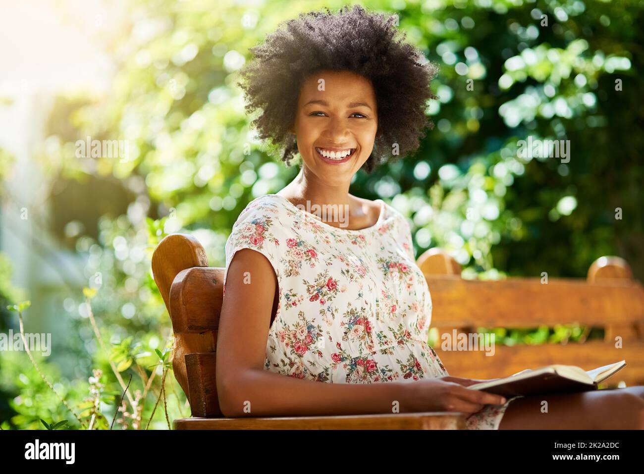 I could read all day everyday. Shot of a young woman relaxing with a ...