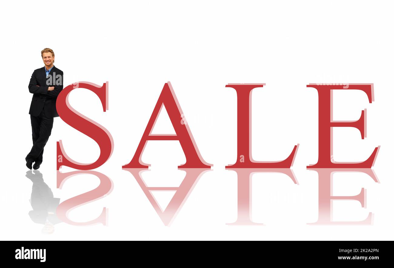 Young salesman leaning by sale sign over white. Young salesman leaning ...