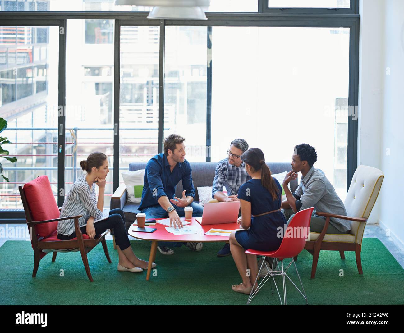 Ideas are flowing. Shot of a group of office workers talking together ...