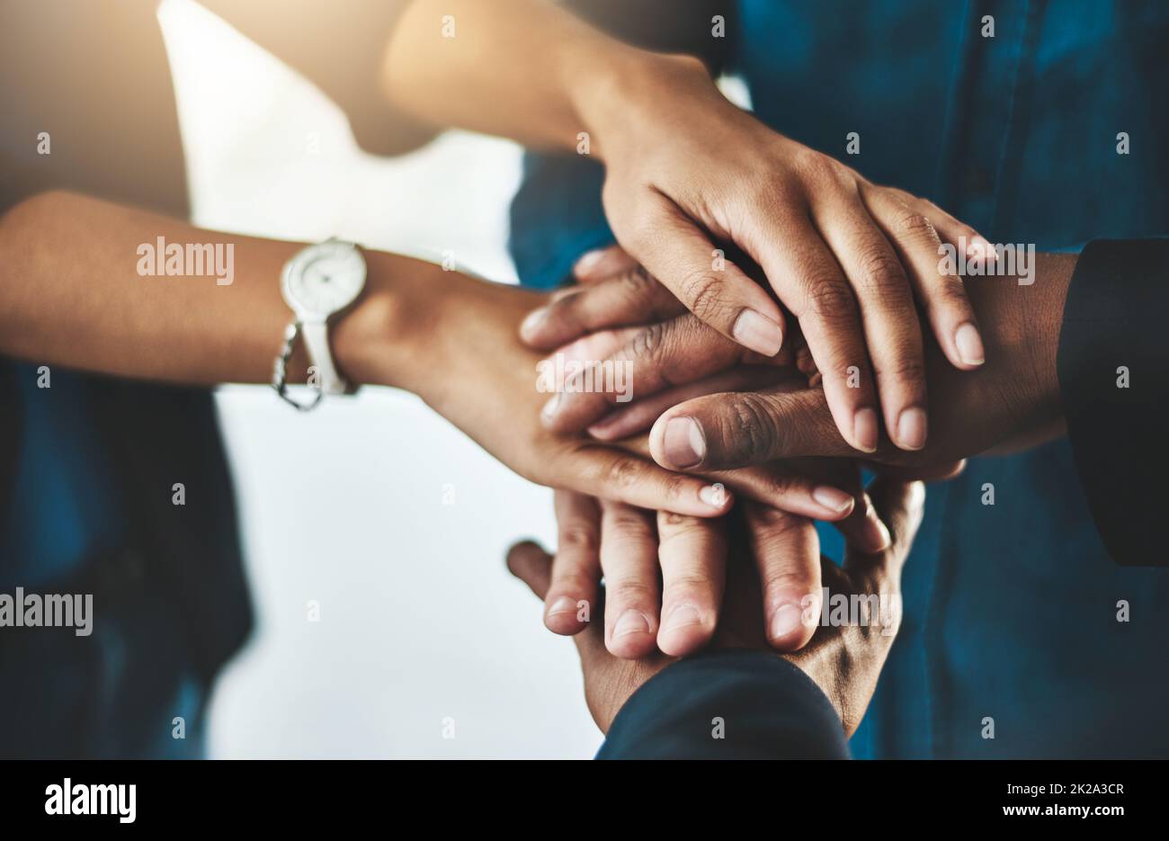 One dedicated team working towards their dream. Closeup shot of a group ...