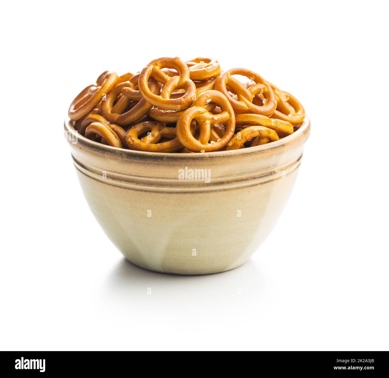 Mini pretzels in bowl. Crusty salted snack isolated on white background ...
