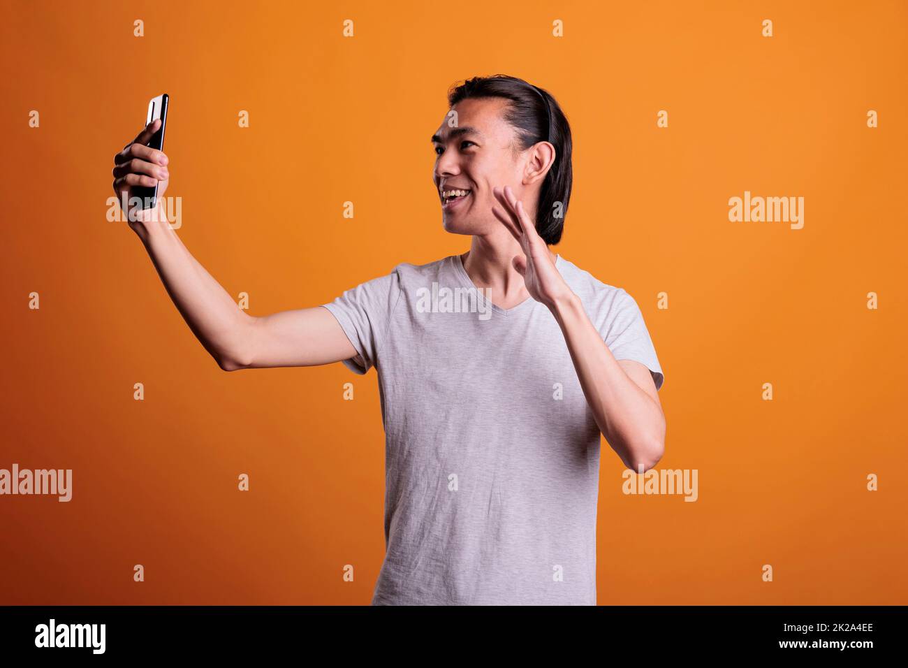 Smiling young man chatting on smartphone video conference. Remote ...