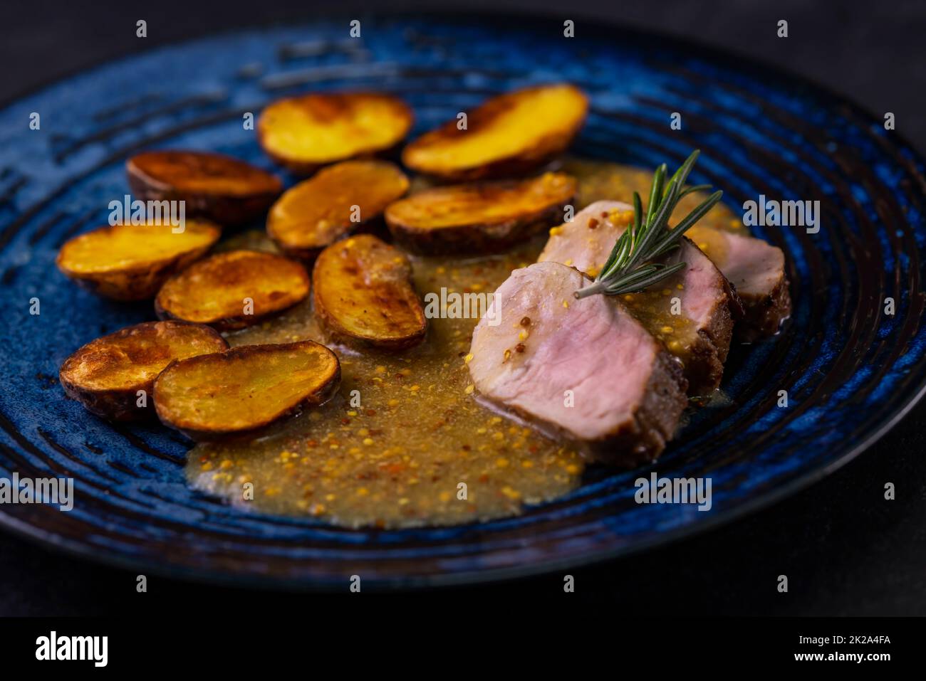 pork tenderloin with baked potatoes and French coarse mustard sauce ...