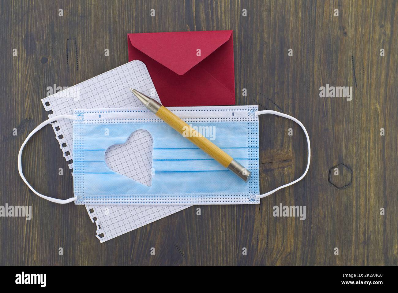 Medical mask alongside notepad and red envelope Stock Photo - Alamy