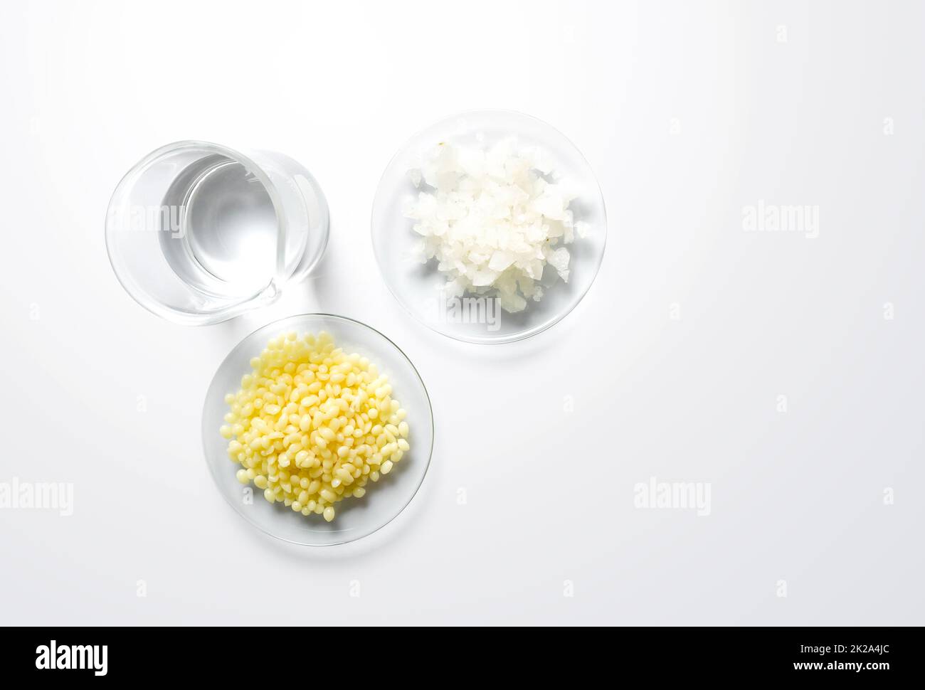 Crystal clear liquid in beaker, Flake salt and Candelilla Wax in ...
