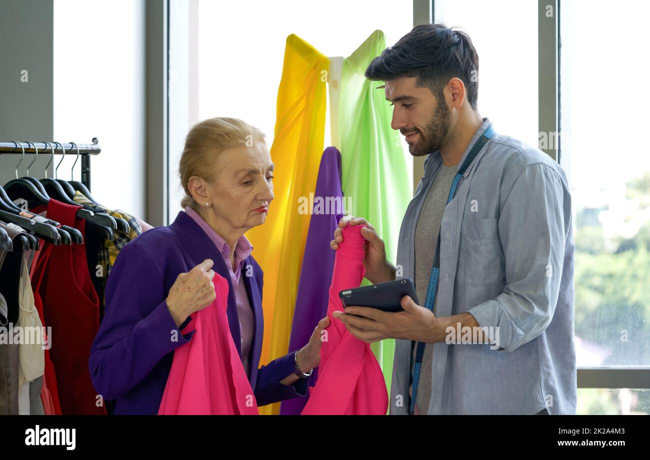 Fashion designer room, man and woman working in home base cloth design ...