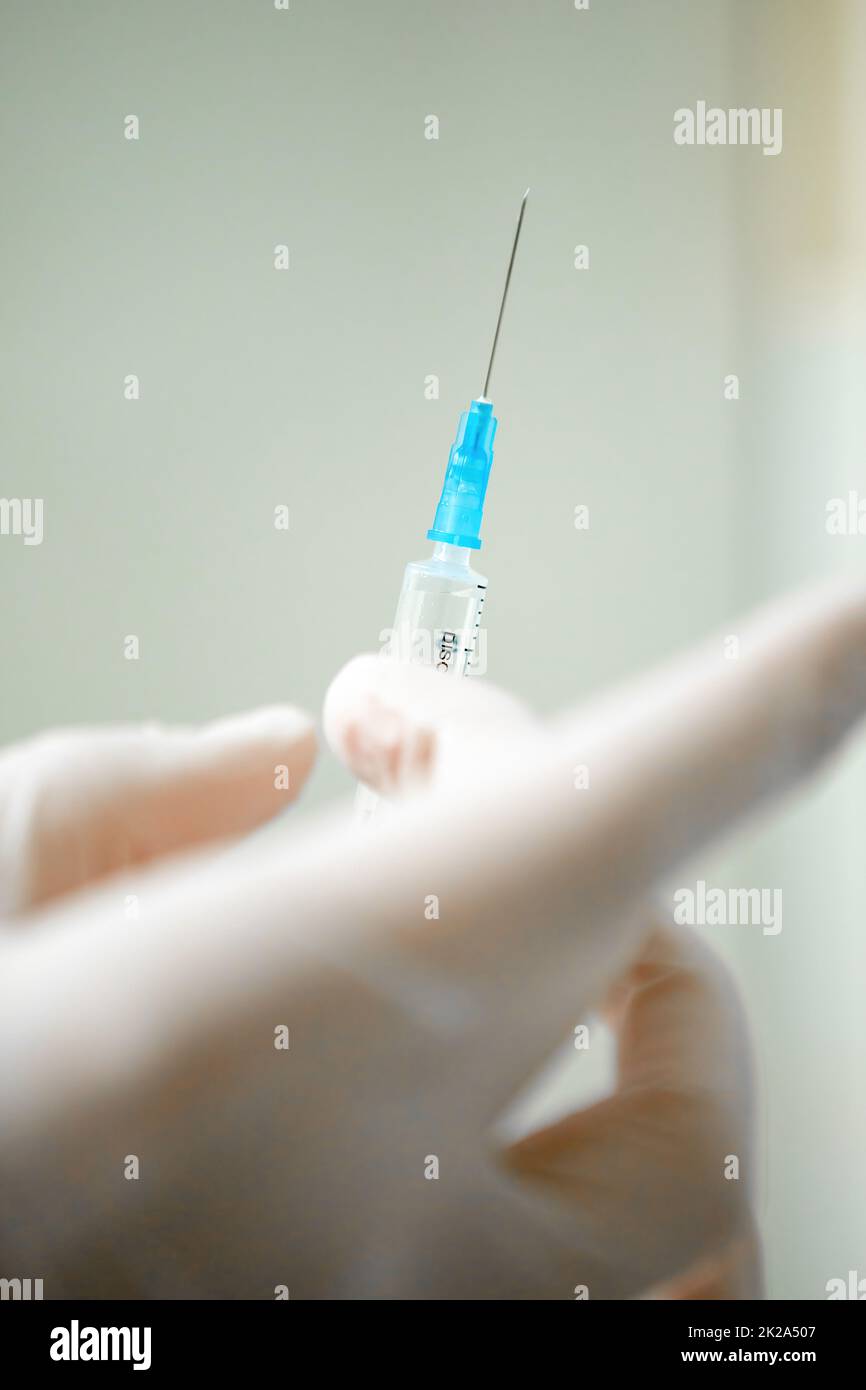 Infusion syringe in the hands of a nurse. Selective focus Stock Photo ...