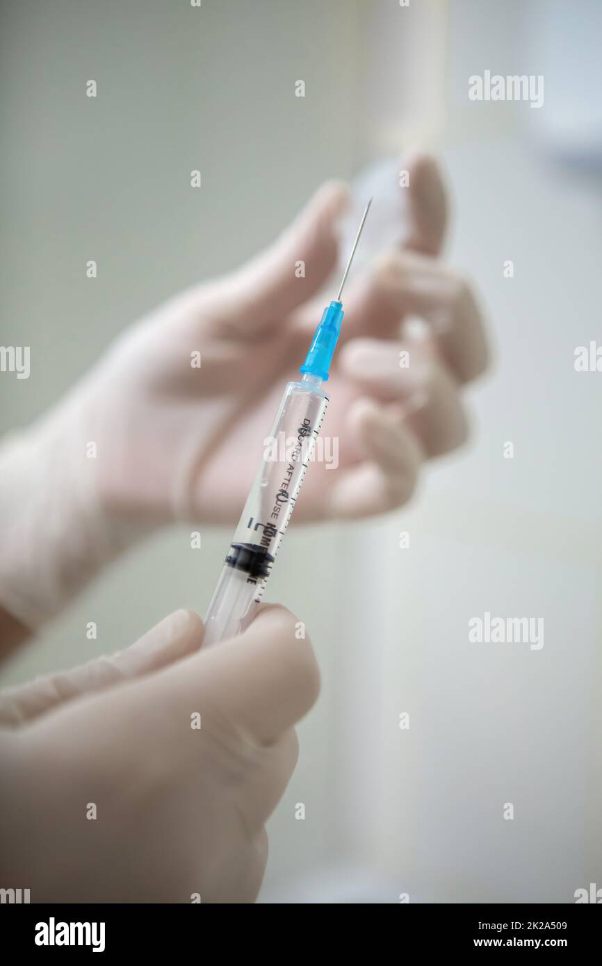 Infusion syringe in the hands of a nurse. Selective focus Stock Photo ...