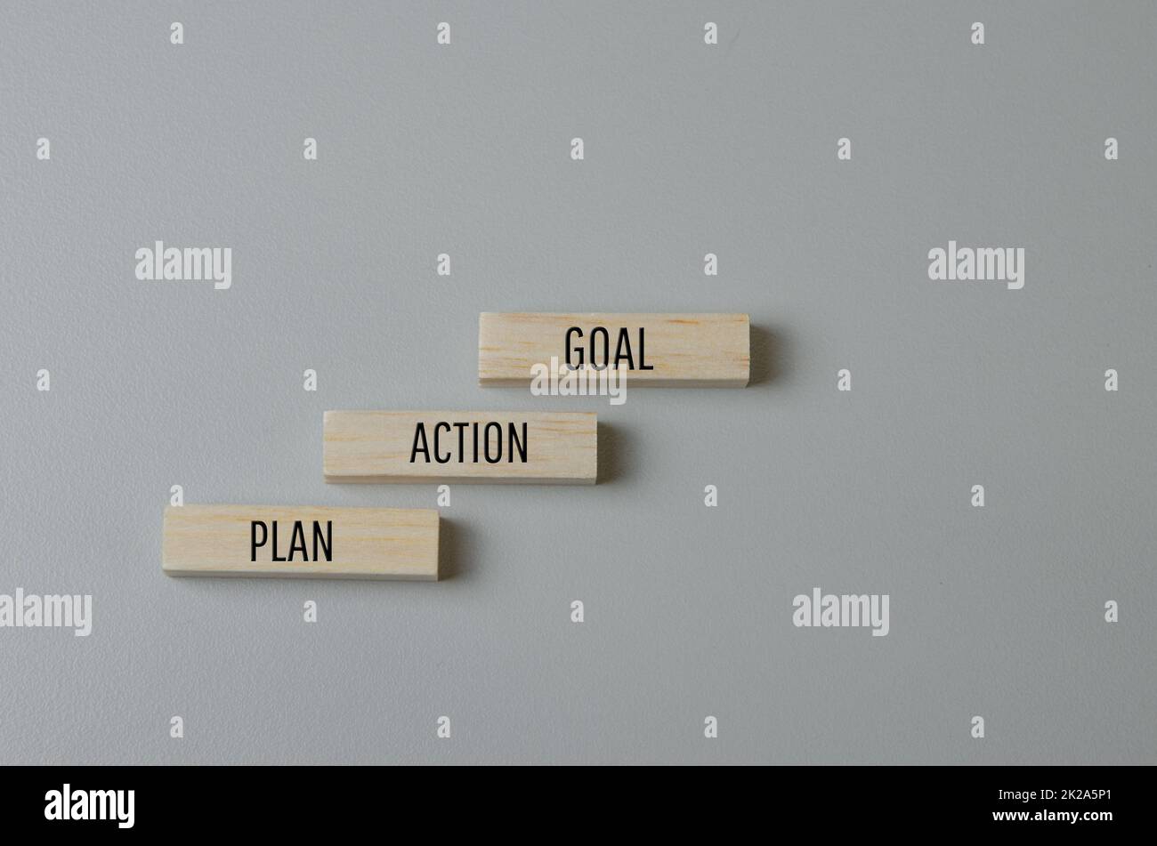 Wooden blocks with words Plan Action Goal on background and copy space ...