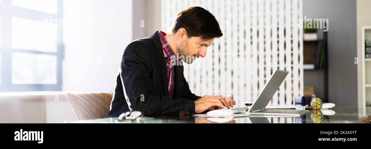 Man Sitting In Bad Posture Working On Computer Stock Photo - Alamy