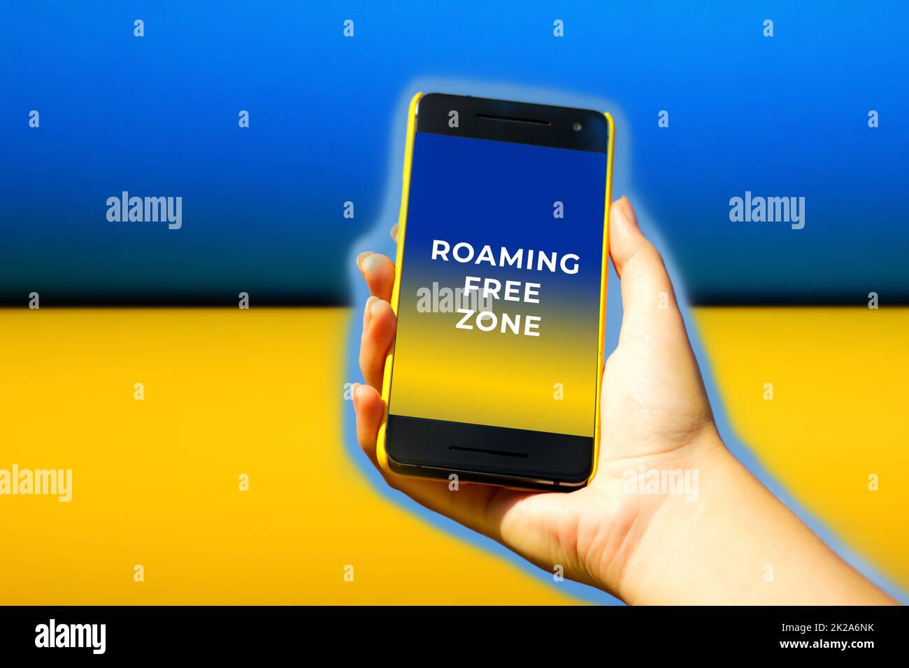 Roaming Free Euro Zone. Woman hand holding black smartphone in yellow ...