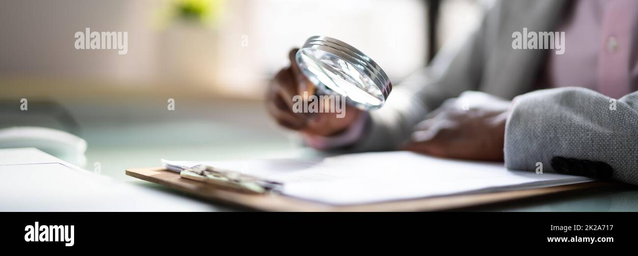 Corporate Auditor Using Magnifying Glass Stock Photo - Alamy