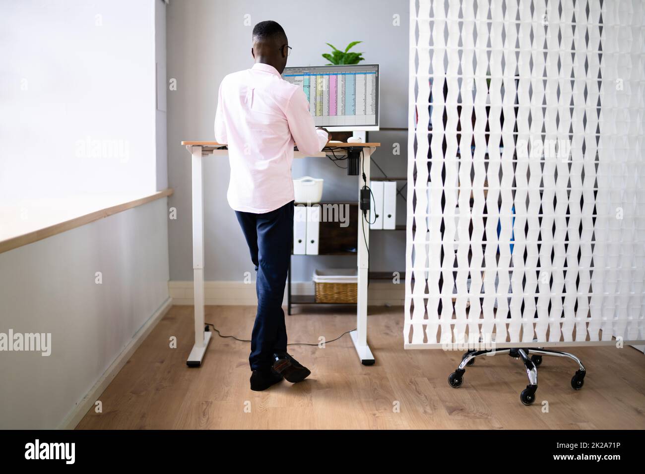 Adjustable Height Desk Stand In Office Stock Photo - Alamy