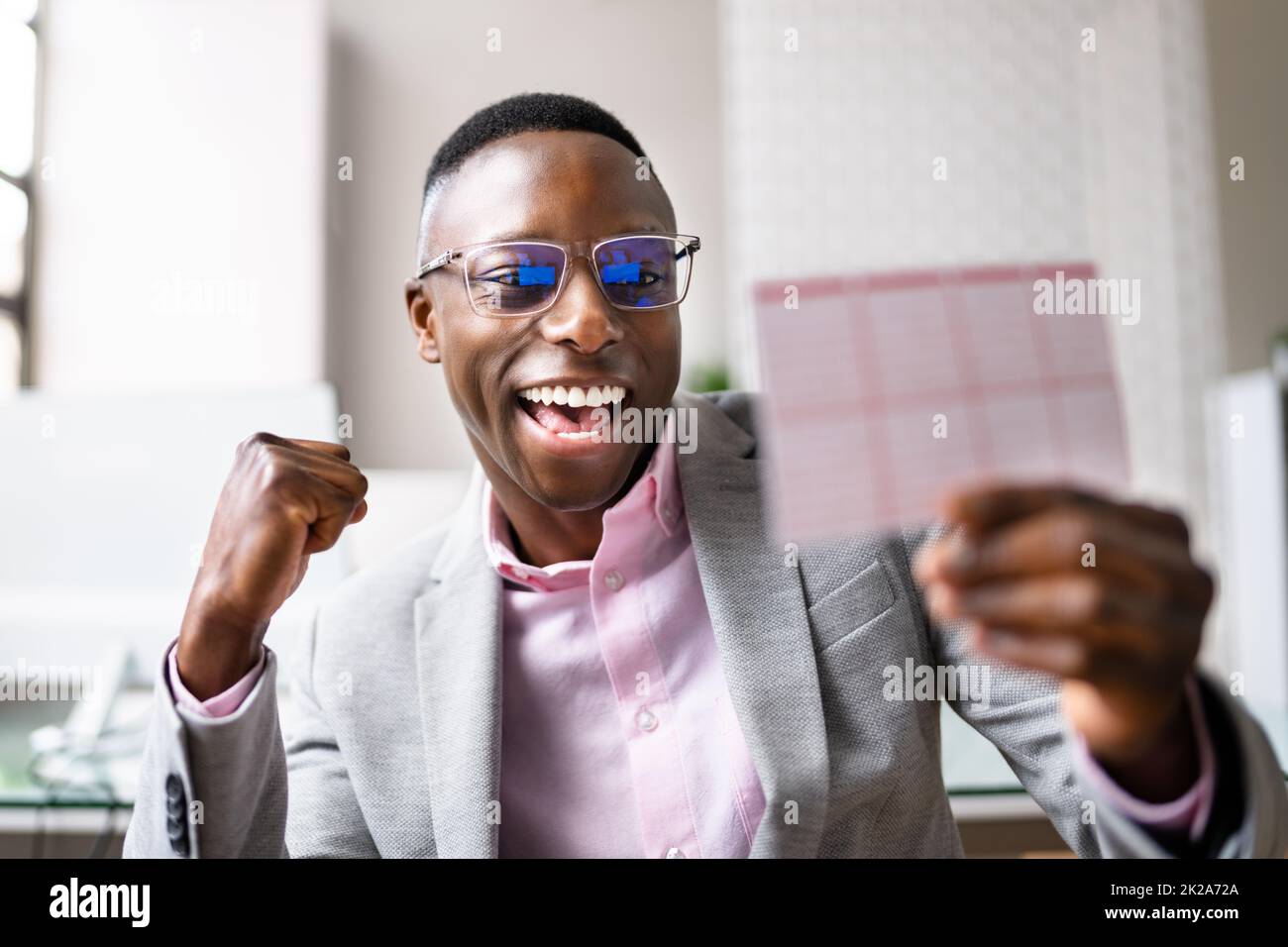 Happy Man Looking At Winning Ticket Stock Photo - Alamy