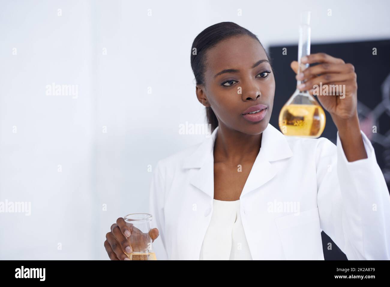 Examining The Results Of Her Experiment Shot Of An Attractive Female Scientist Conducting An