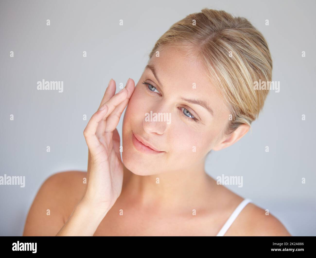 Woman hand touching face hi-res stock photography and images - Alamy