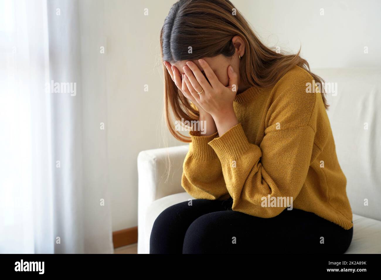 Young sad beautiful woman suffering depression crying worried at home ...