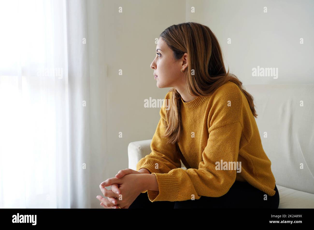 Young woman sad window hi-res stock photography and images - Alamy