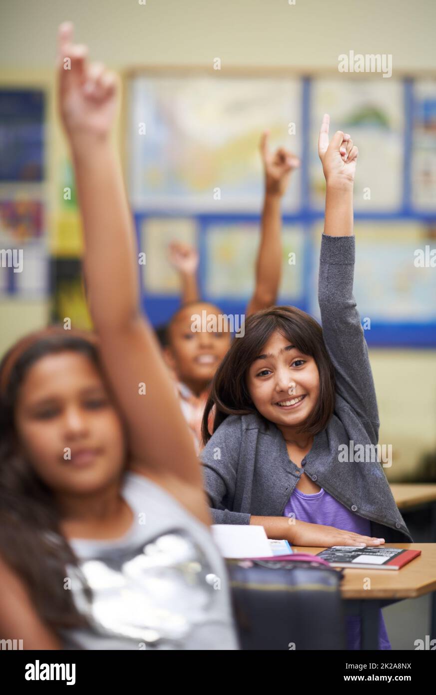 Kids raising hands in class hi-res stock photography and images - Alamy