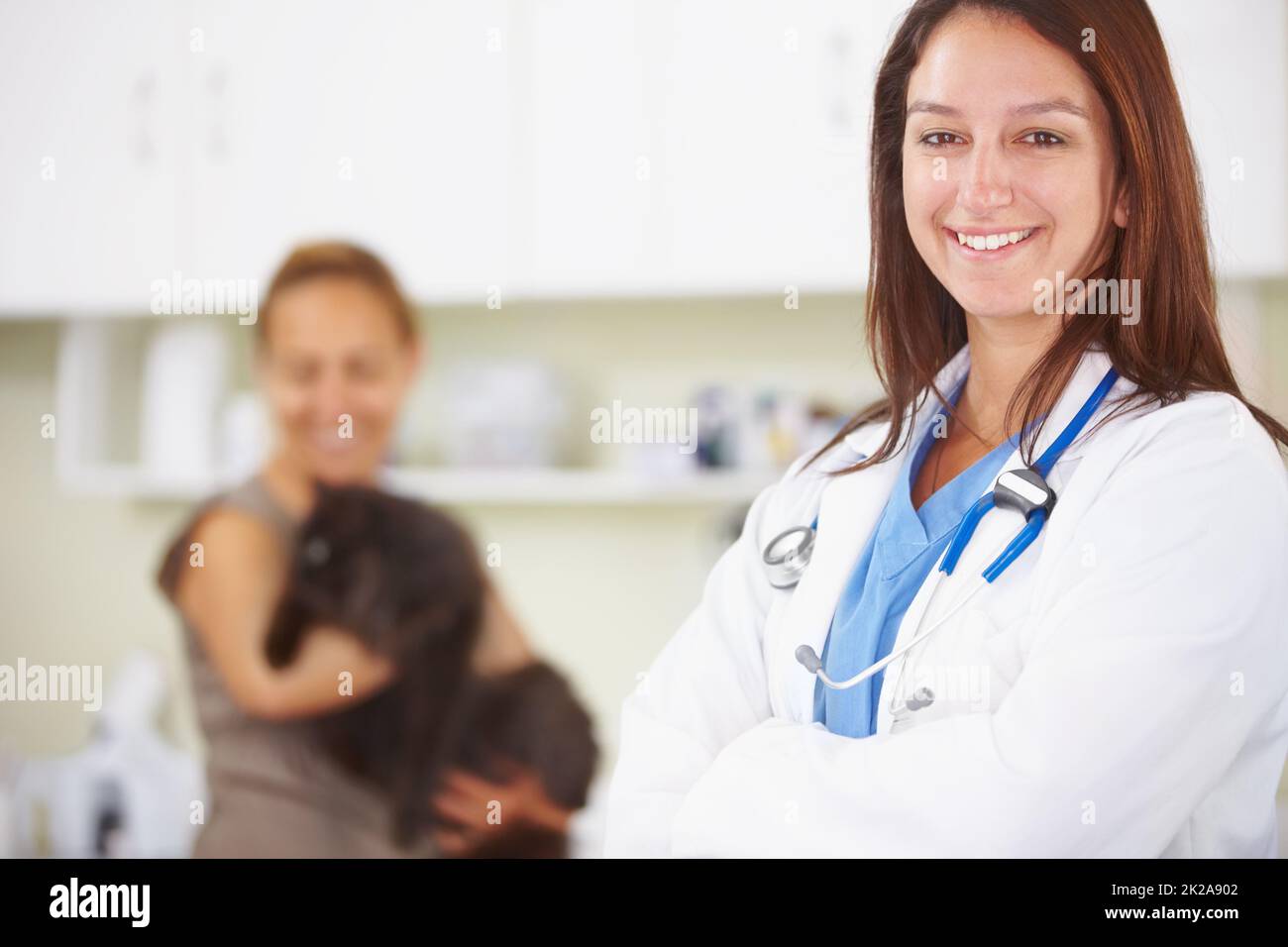 Another happy pet owner. A portrait of a smiling female vet with a pet ...