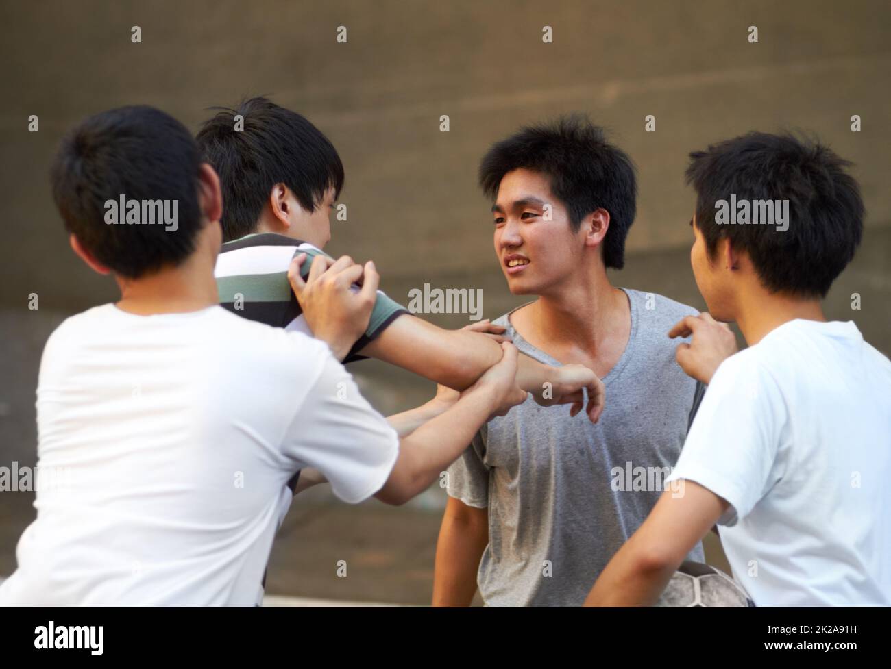 Boy shoving friend hi-res stock photography and images - Alamy