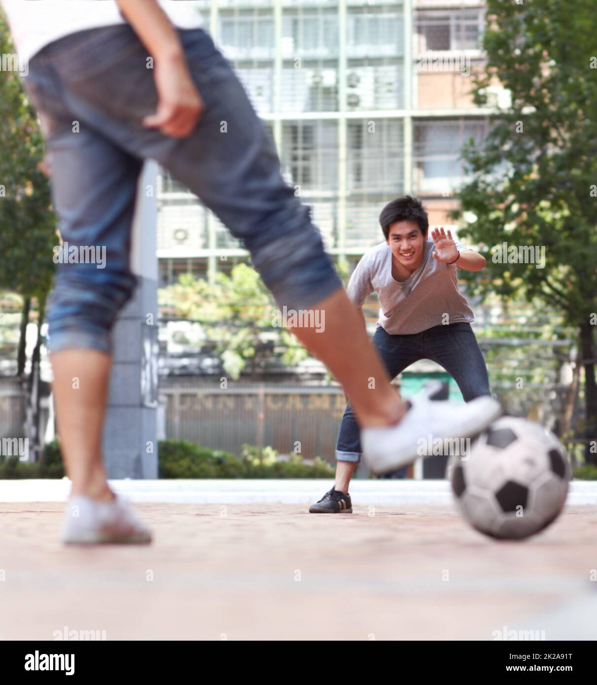 Rear view man kick ball hi-res stock photography and images - Alamy