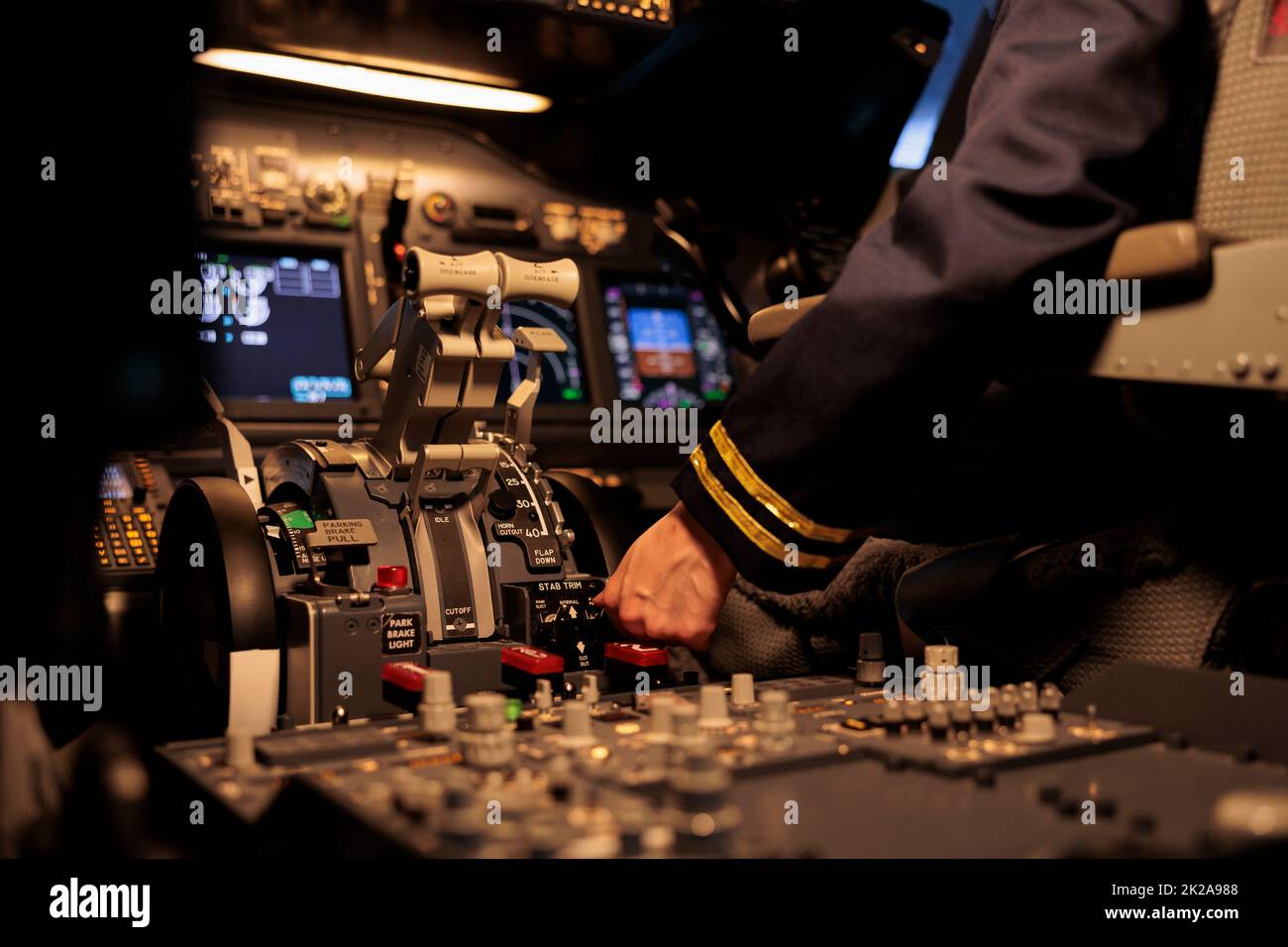 Woman airliner pushing dashboard buttons in plane cockpit, preparing to ...