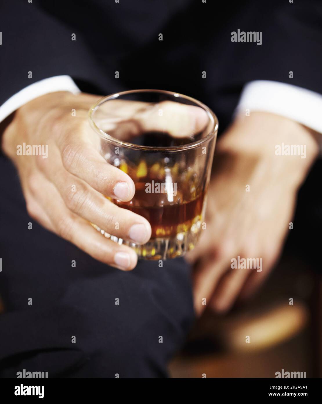 Hand holding whiskey glass hi-res stock photography and images - Alamy
