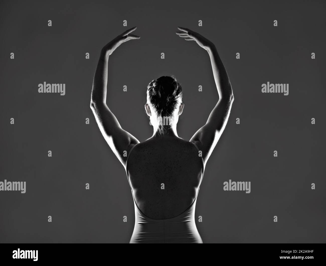 She lives to dance. Silhouette of a young ballerina dancing against a ...