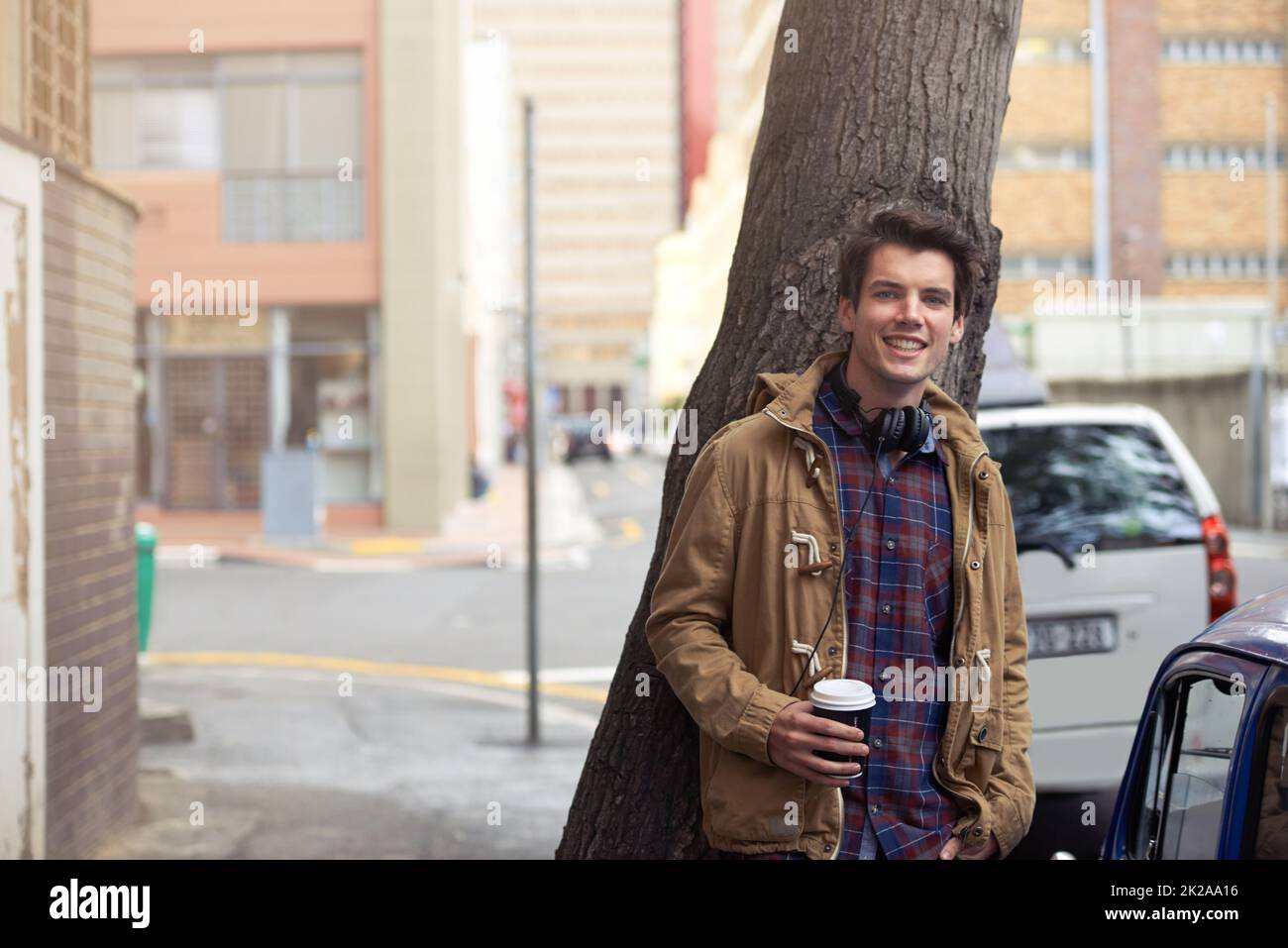 Out and about, around downtown. a handsome young man chilling in a ...