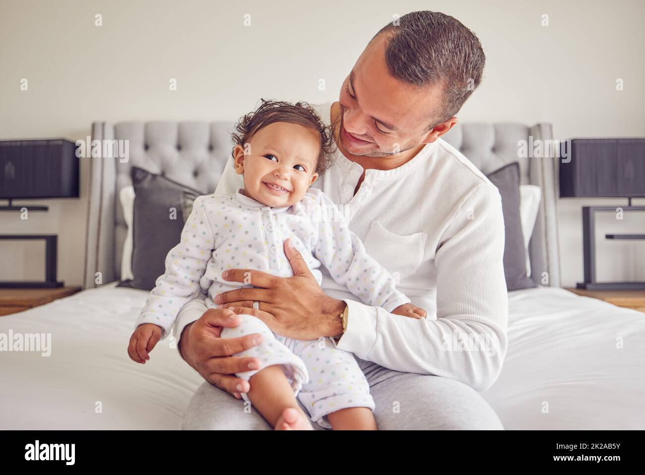 Happy baby and father relax in a bedroom portrait for love, support and ...