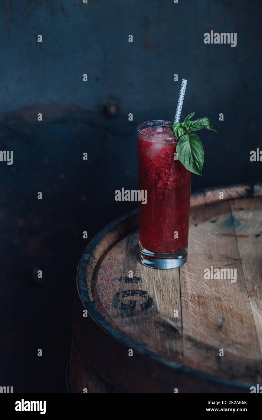 strawberry basil cocktail drink in tall Collins glass with drinking ...